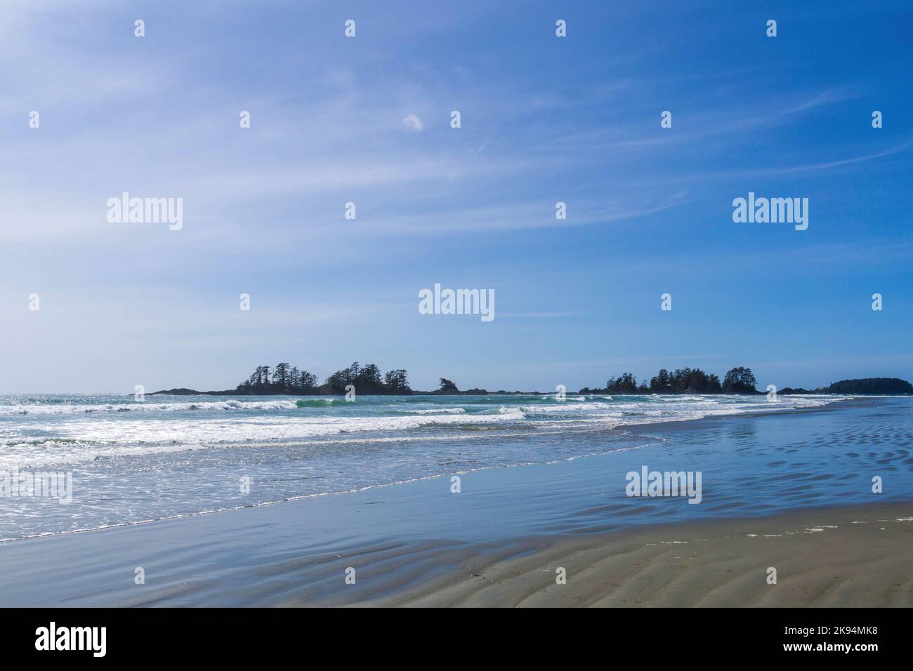 A scenic view of ocean waves washing the sandy beach of Vancouver ...