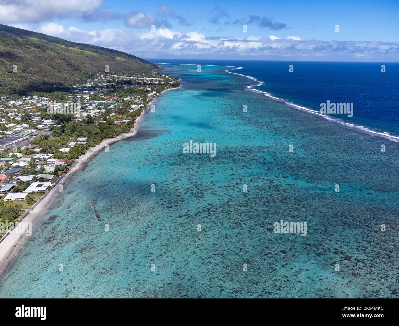 A bird's eye view of a city in Paea valley in Tahiti, Polynesia against ...