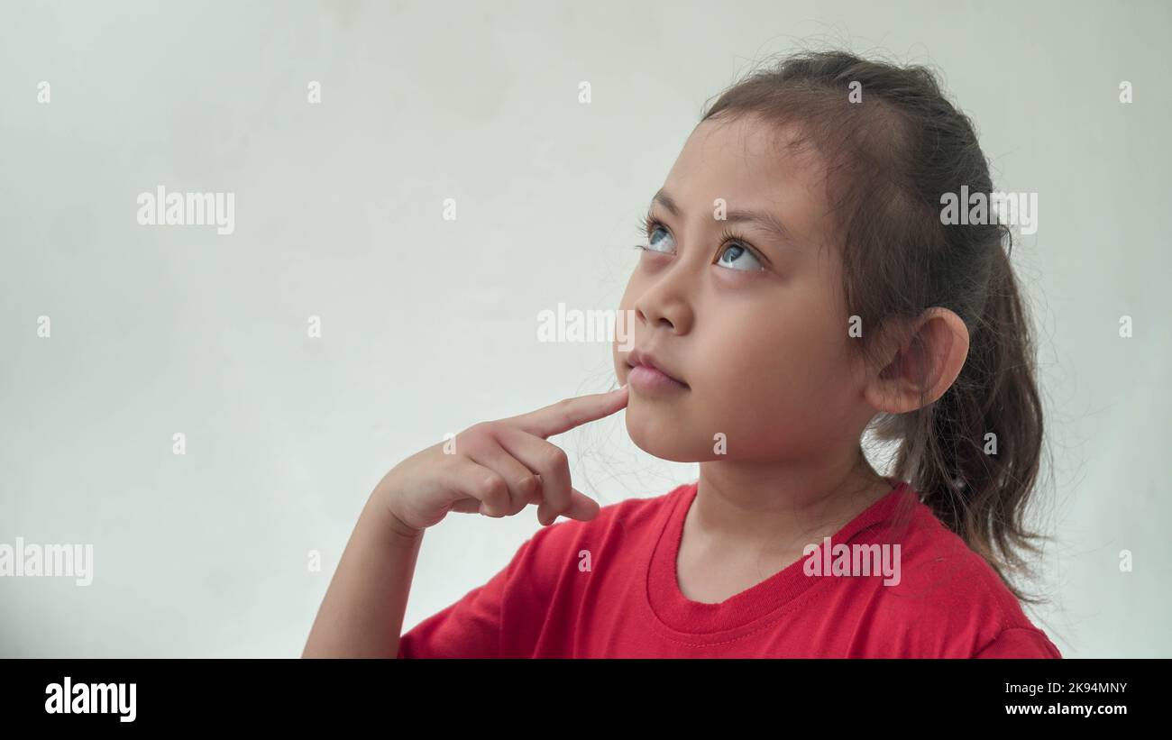 Little Asian Girl looks like thinking something Stock Photo - Alamy