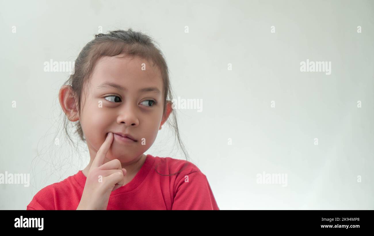 Little Asian Girl looks like thinking something Stock Photo - Alamy