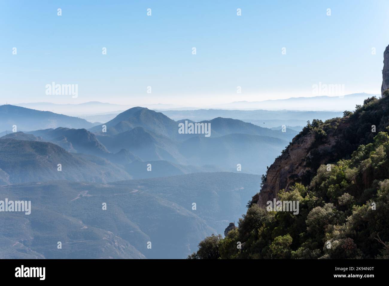 A mountain landscape with misty weather and blue sky Stock Photo - Alamy