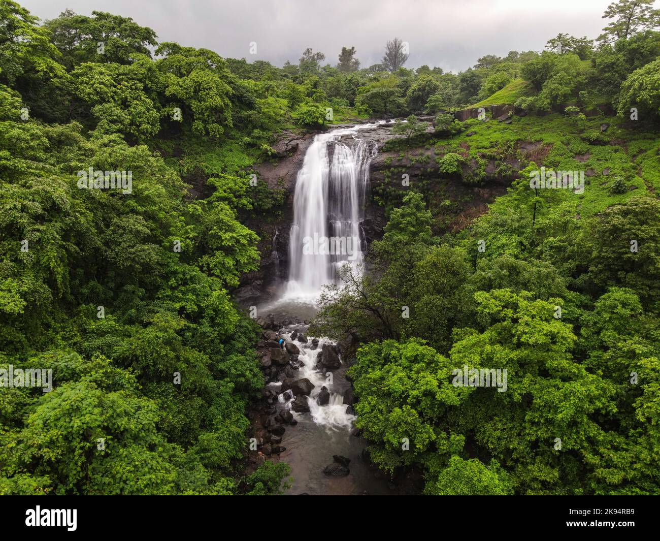 A scenic drone view of Vihigaon Ashoka waterfalls flowing through rocks ...