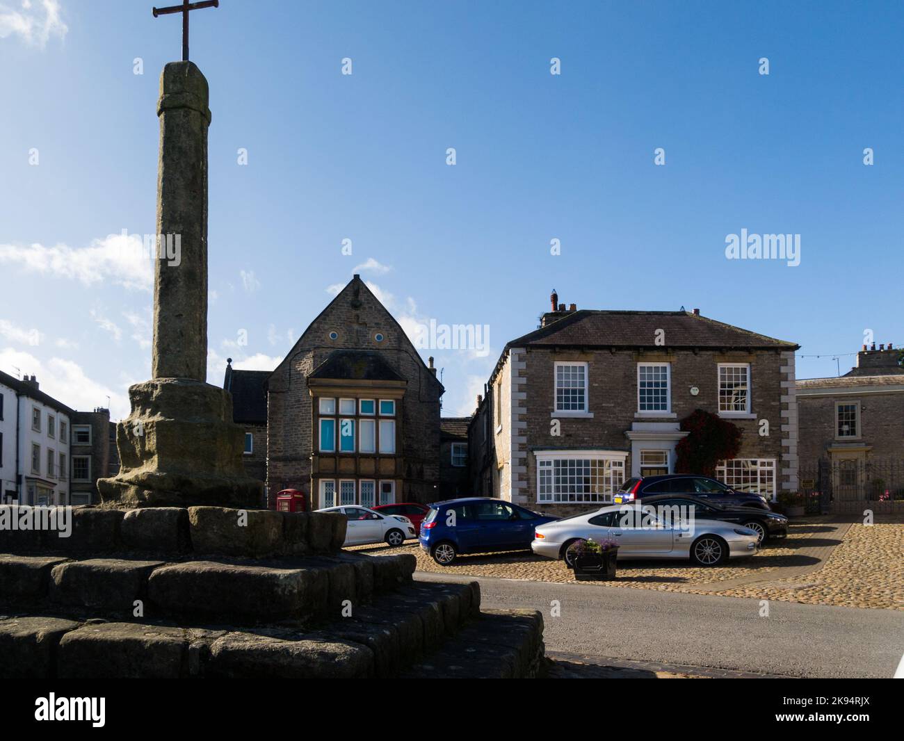 Stone cross in the centre of historic town of Middleham in Wensleydale ...