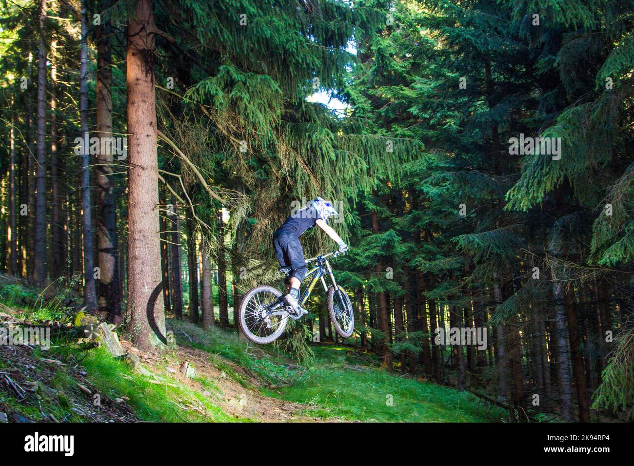 KRONBERG, GERMANY - JULY 7: downhill biker jumps over a ramp in the ...