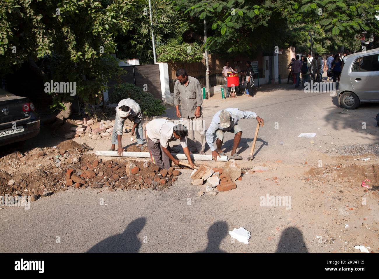 NEW DELHI - OCTOBER 14: worker repair the drain system on October 14 ...