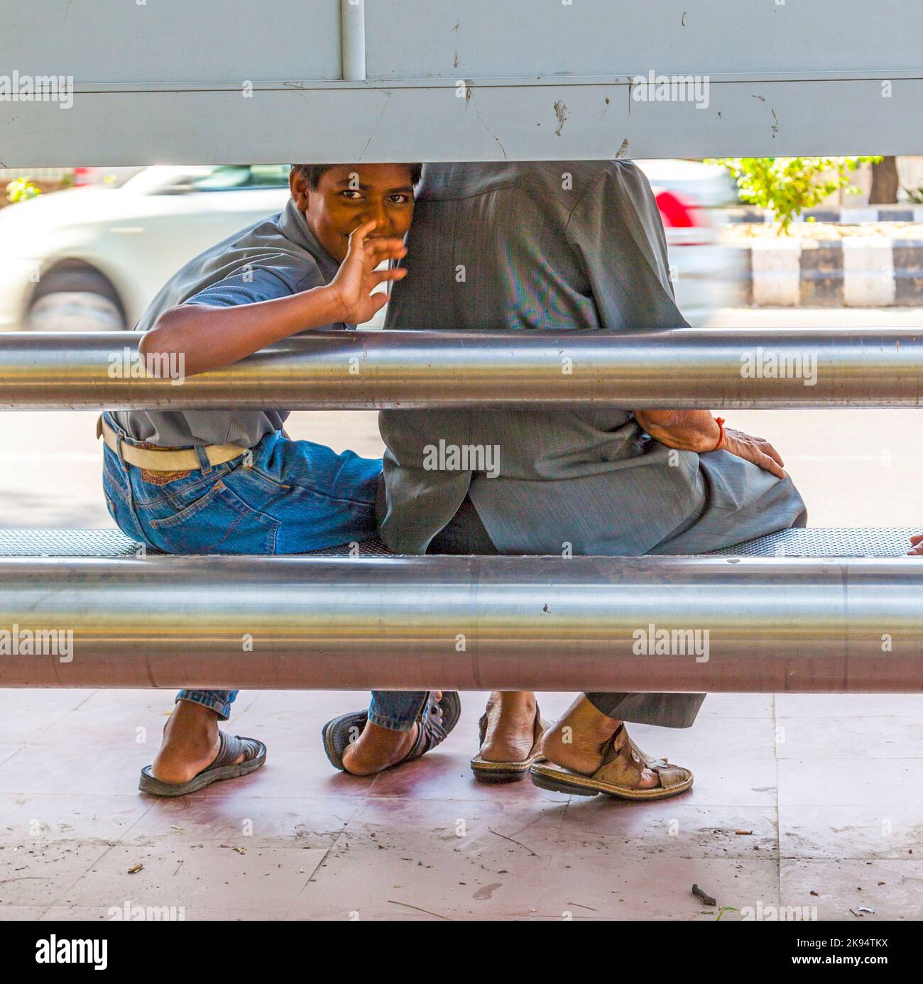 DELHI, INDIA - OCTOBER 14: boy waits for the bus on October 14,2012 in ...