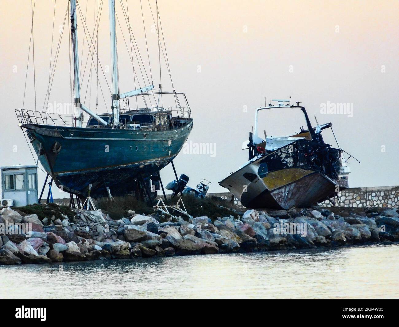 A burned speed boat and a yacht Stock Photo - Alamy