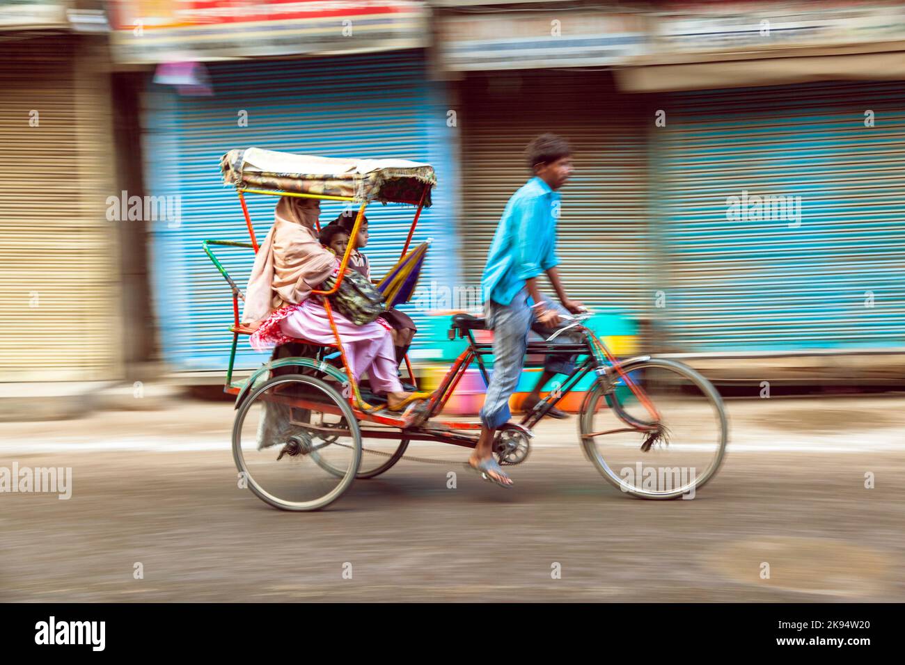 DELHI, INDIA - OCT 16: Rickshaw rider transports passenger early ...