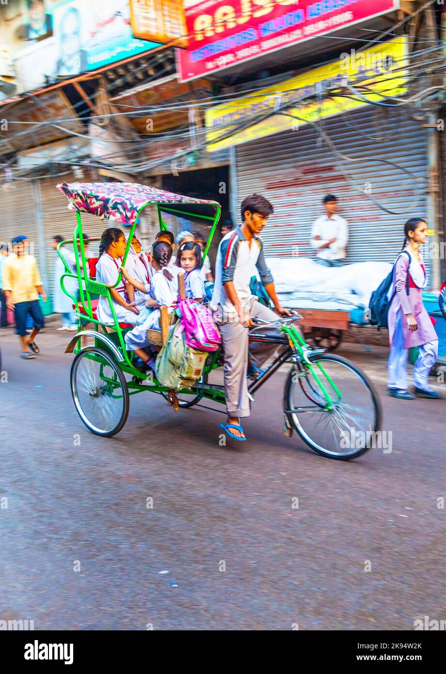 DELHI, INDIA - OCT 16: Rickshaw rider transports passenger early ...