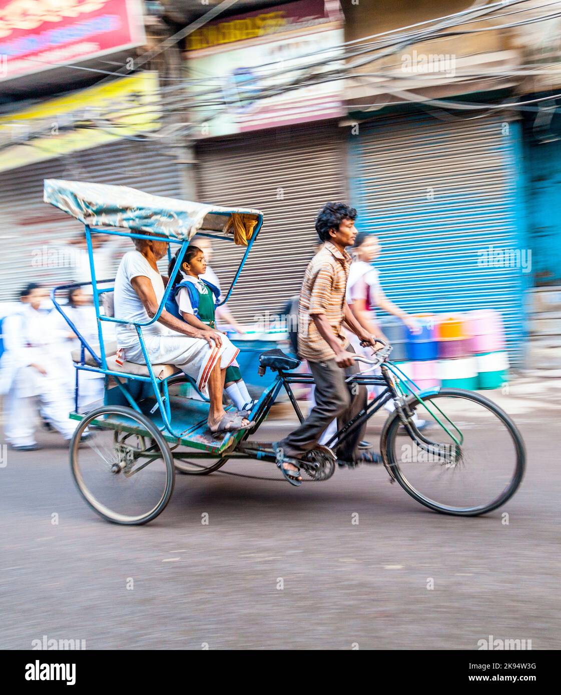 DELHI, INDIA - OCT 16: Rickshaw rider transports passenger early ...