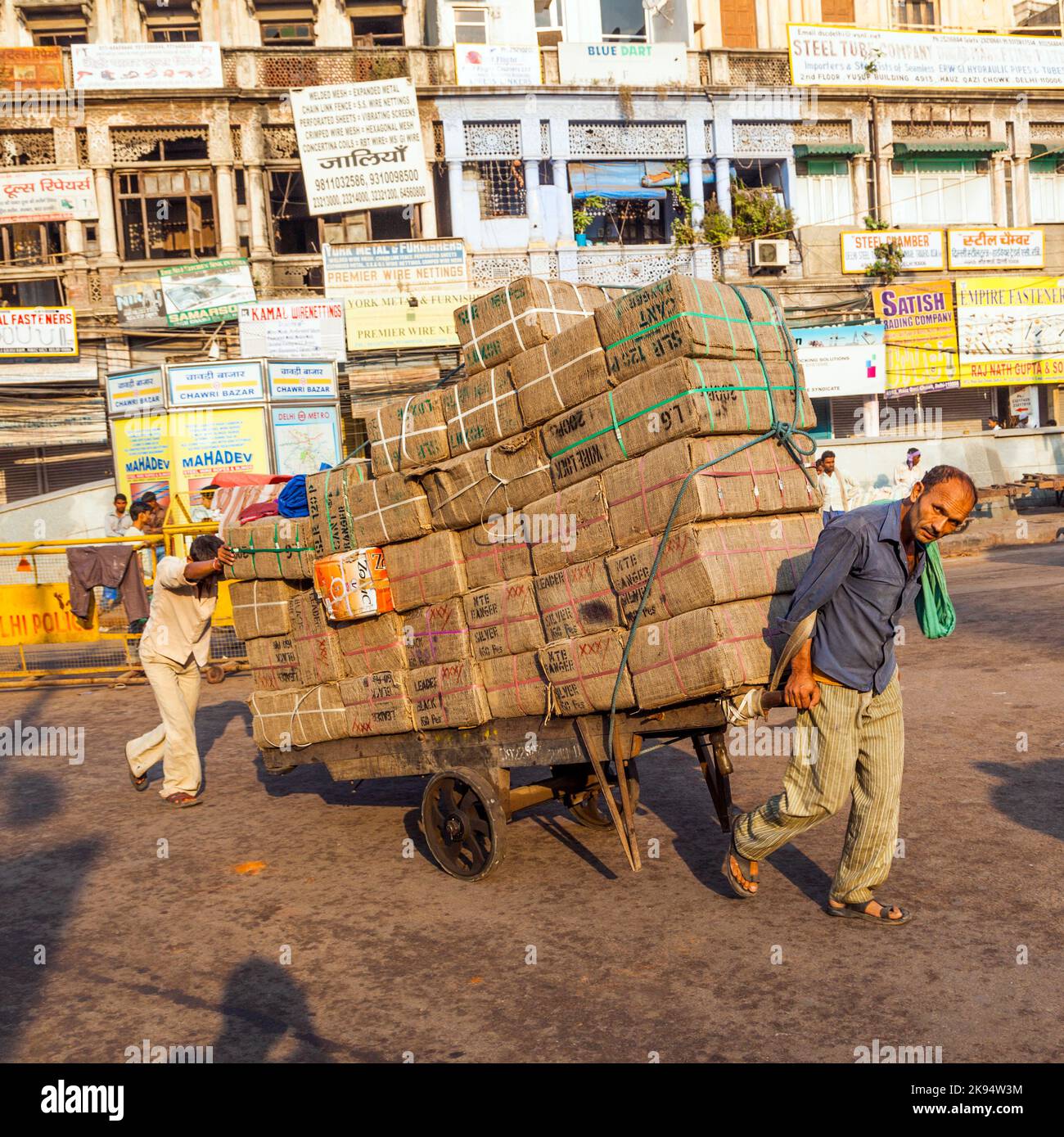 DELHI, INDIA - OCT 16: Rickshaw rider transports heavy goods on OCT 16 ...