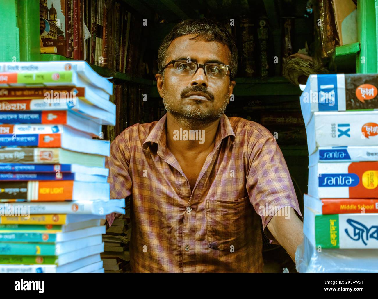 Kolkata, India - July 9, 2022: A middle aged man selling book inside a ...