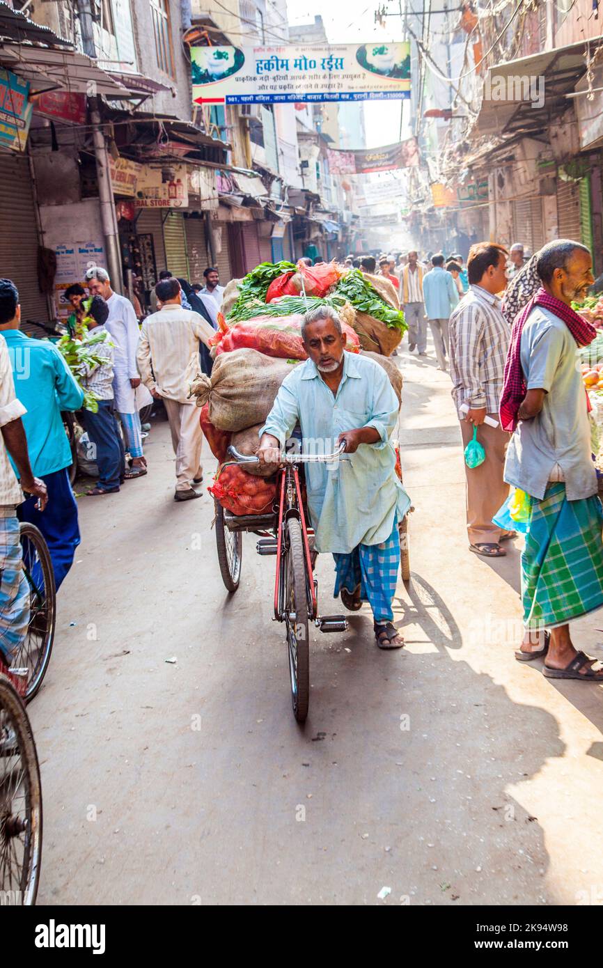 DELHI, INDIA - OCT 16: Rickshaw rider transports vegetables early ...
