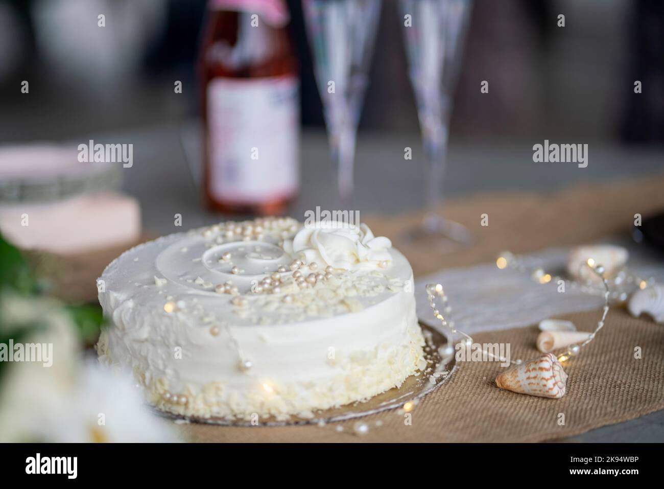 A white party cake on the table with decorations Stock Photo - Alamy