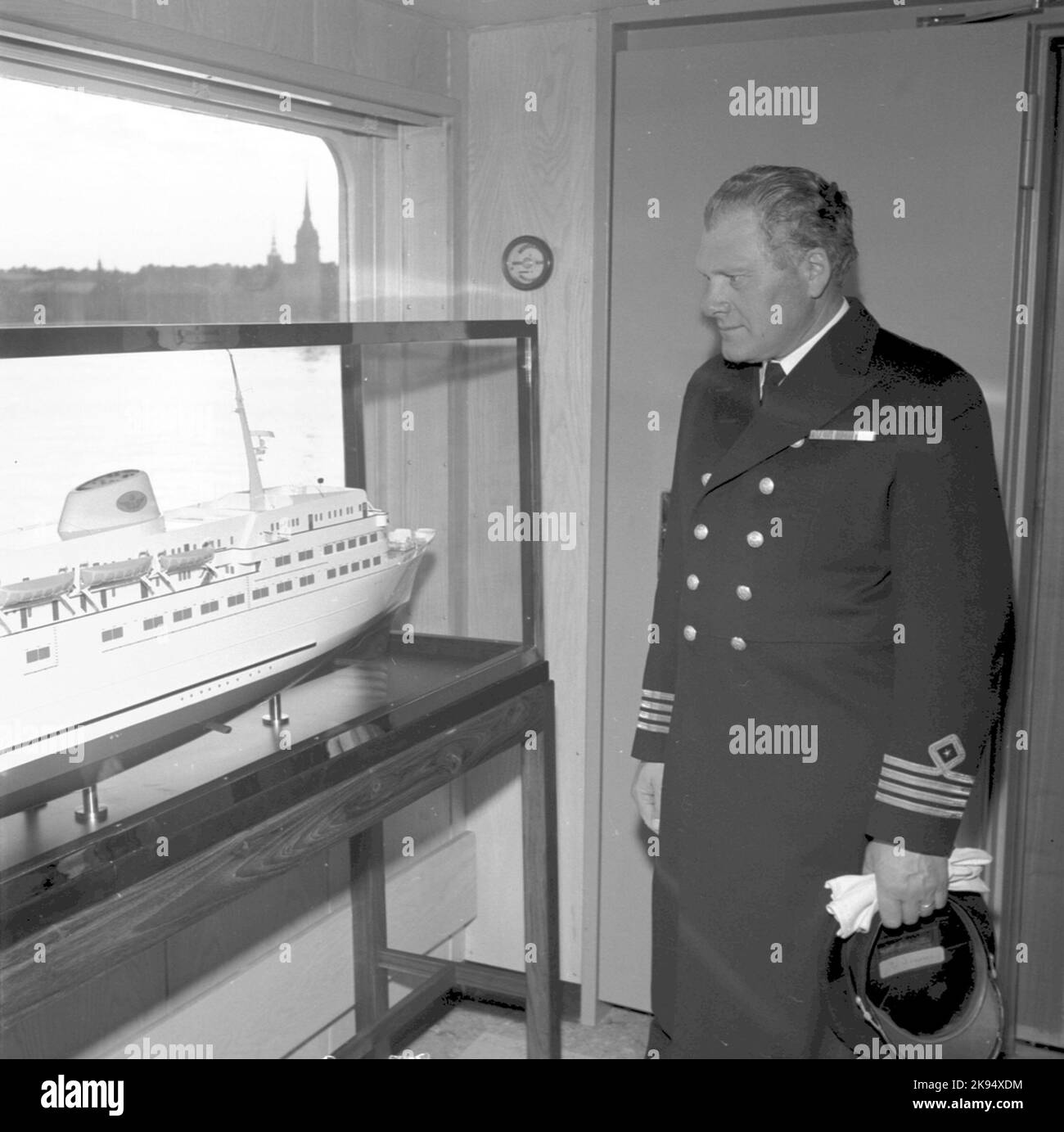 M/S "Trelleborg", cocktail party. Captain C. Karlsson admires model of ...