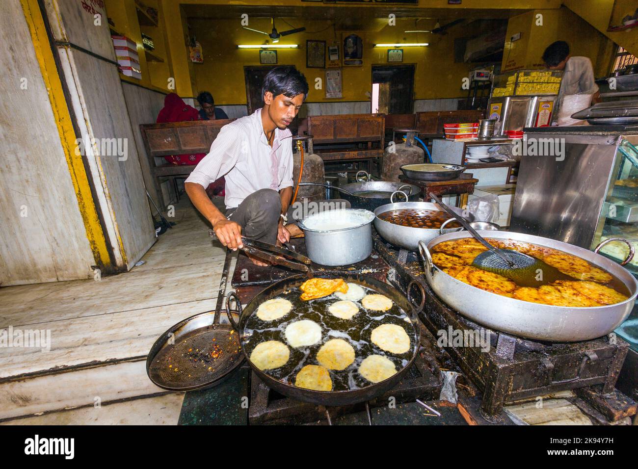 PUSHKAR, INDIA - OCTOBER 20: Local man prepares bakery in a pan on ...