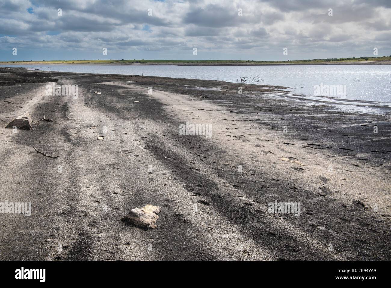 Receding shoreline caused by falling water levels in severe drought ...
