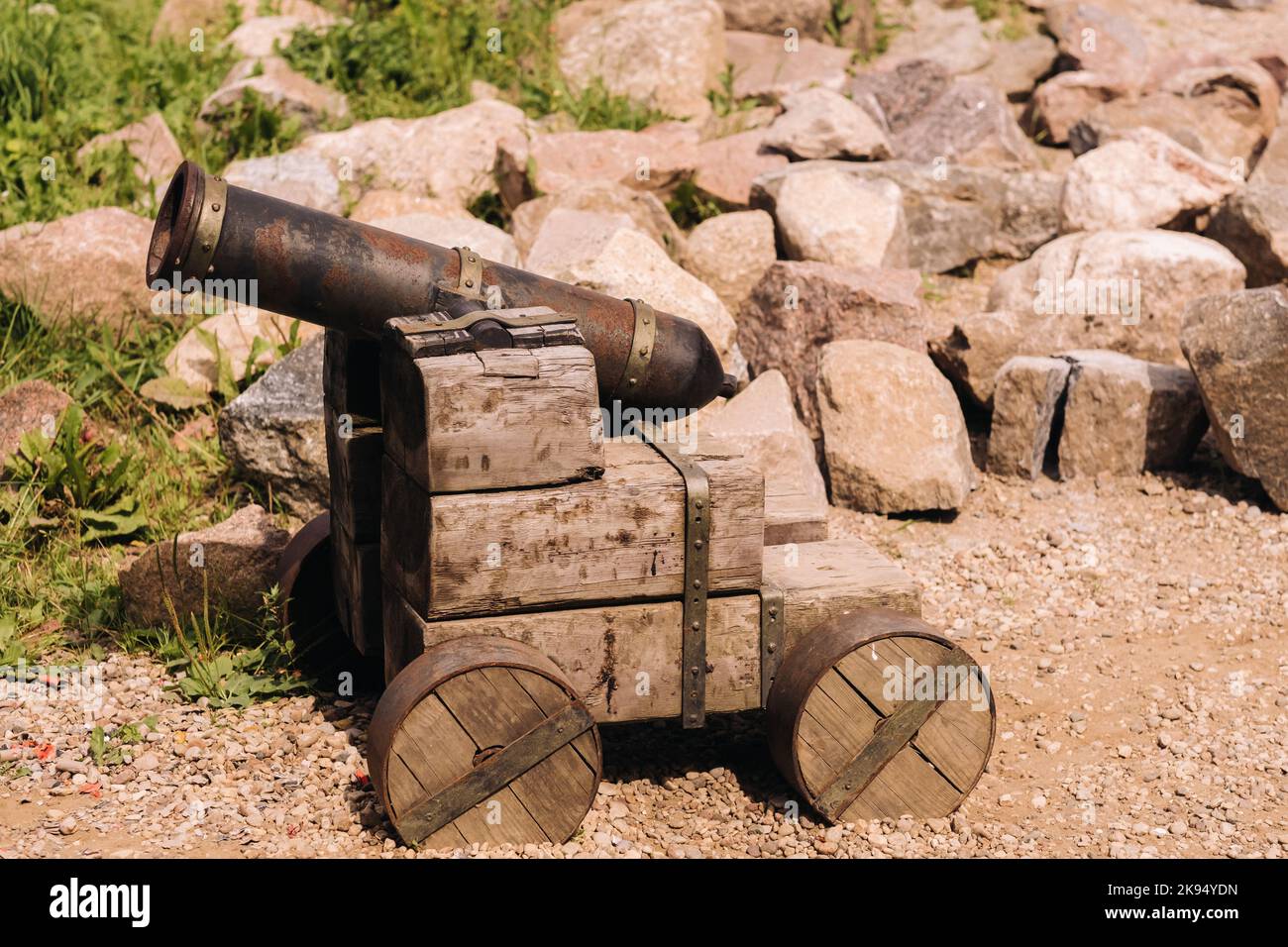 Medieval artillery piece on a wooden carriage standing outside in sunny ...