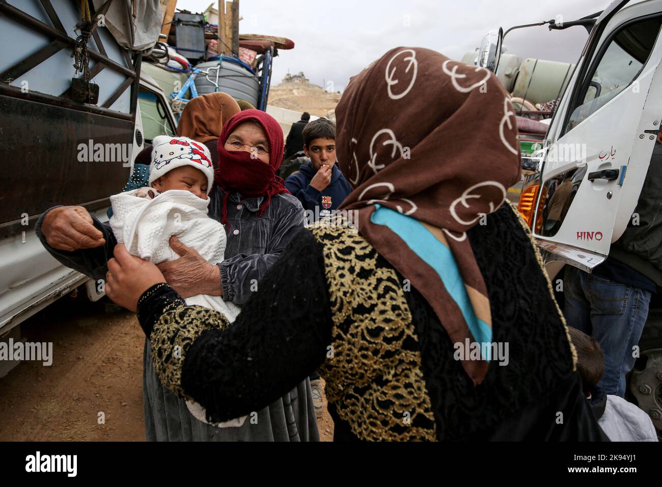 Arsal, Lebanon. 26th Oct, 2022. A Syrian refugee carries her grandson ...