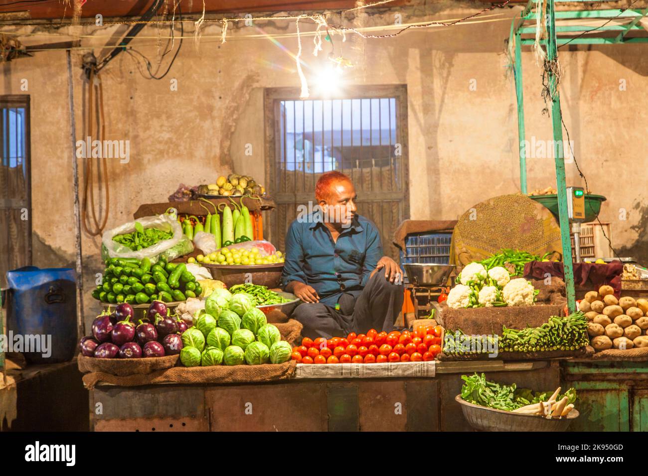 BIKANER, INDIA - OCTOBER 23: Seller at the vegetable night market on ...