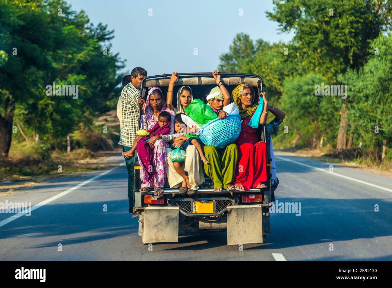 DAOLA, INDIA - 25 OCT: people on highway 71 in overloaded truck on OCT ...
