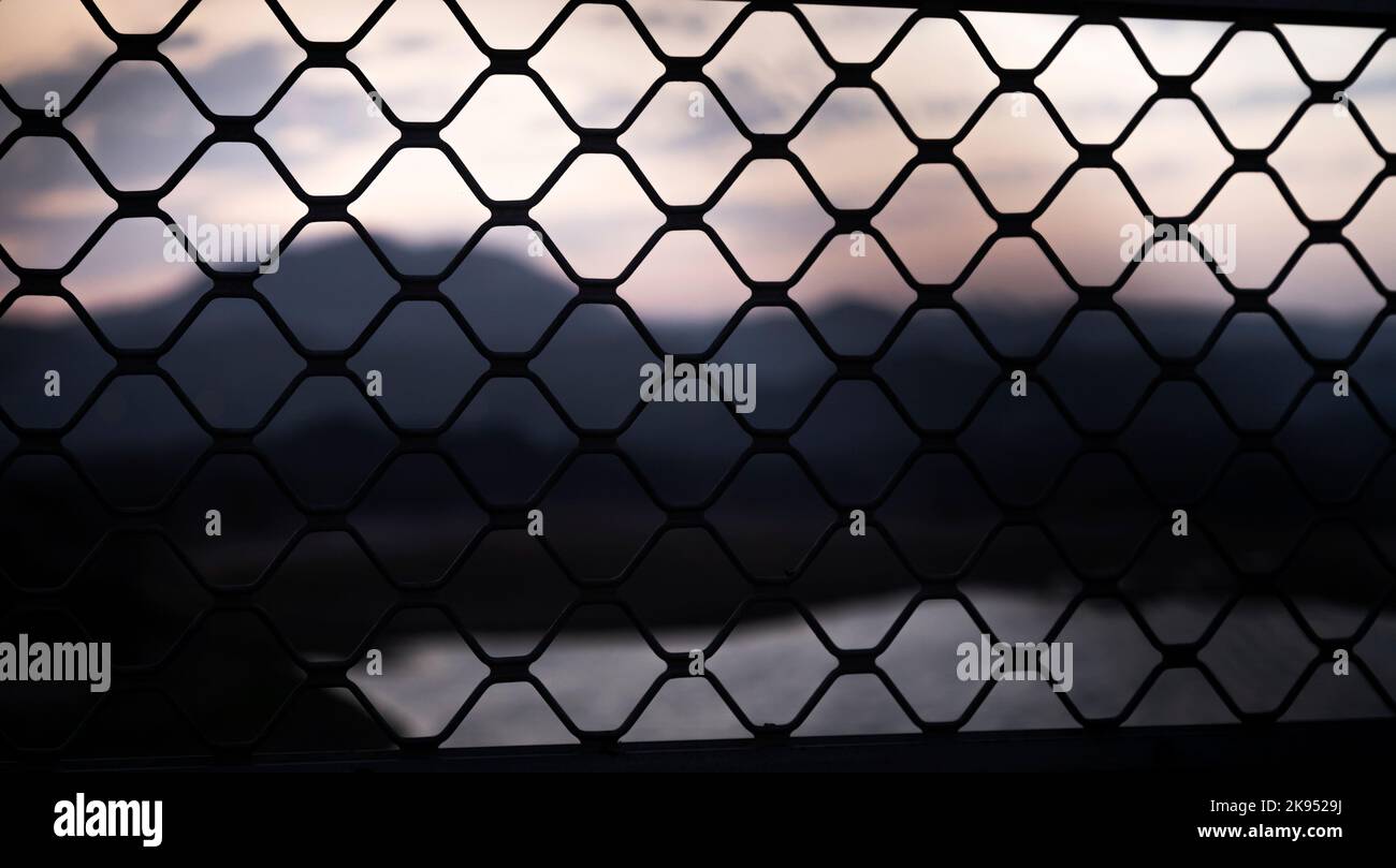 Metal Grill pattern from the Dam with mountain background Stock Photo ...