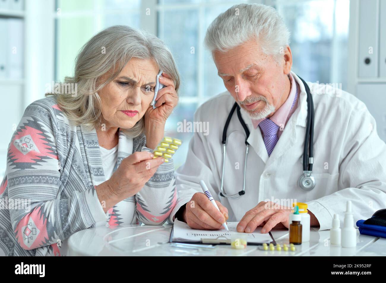 Older adult doctor with emotional elderly patient Stock Photo - Alamy