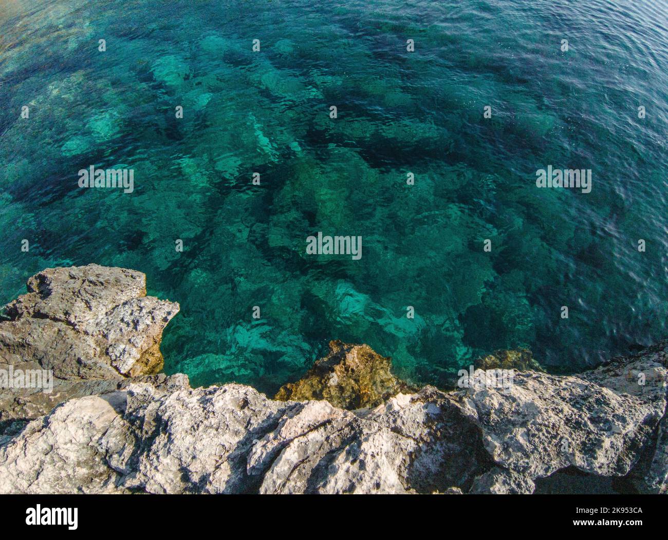A high angle shot of the blue green seawater from over a cliff Stock ...