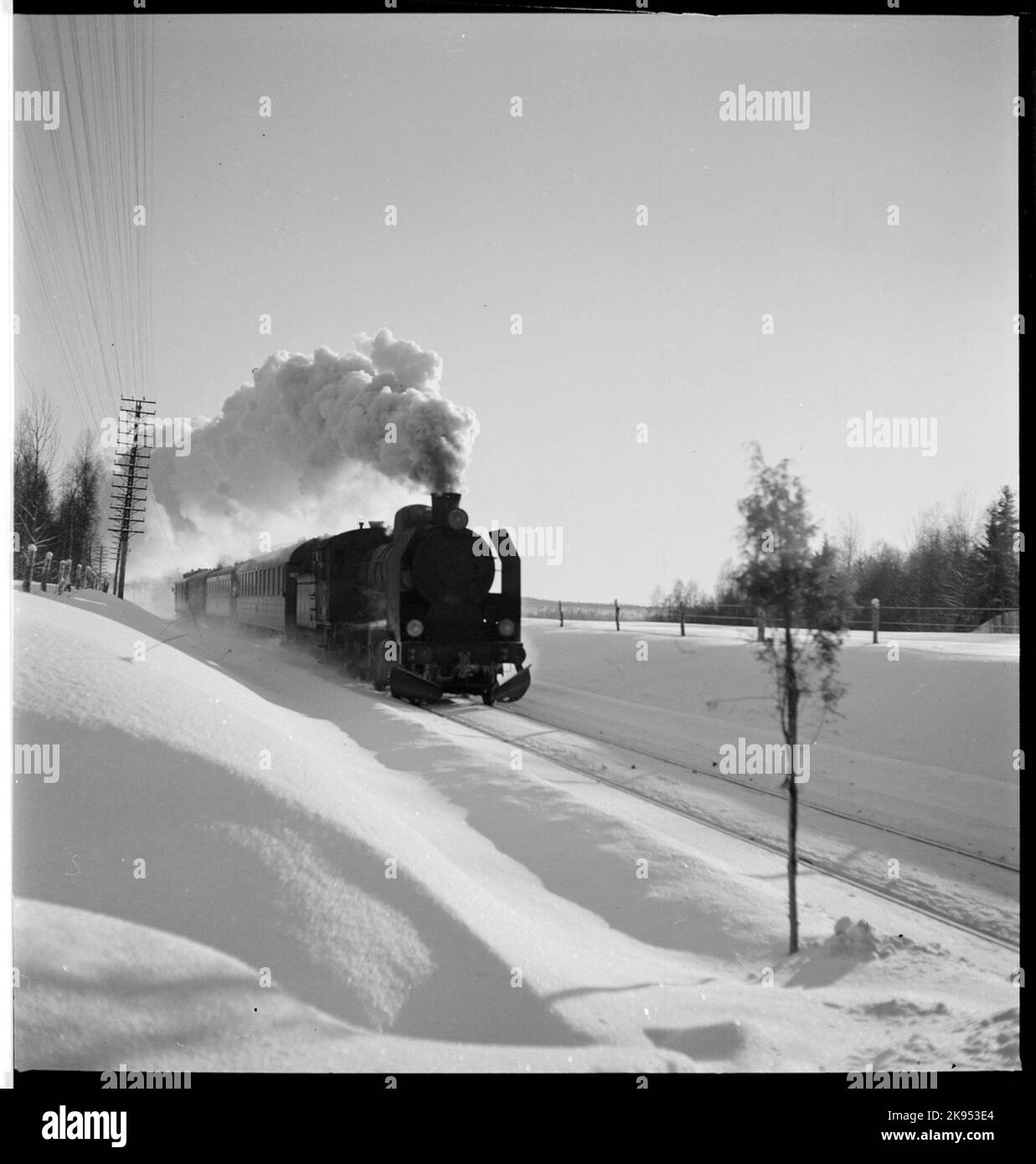 Steam locomotive with passenger cars in winter landscapes Stock Photo ...