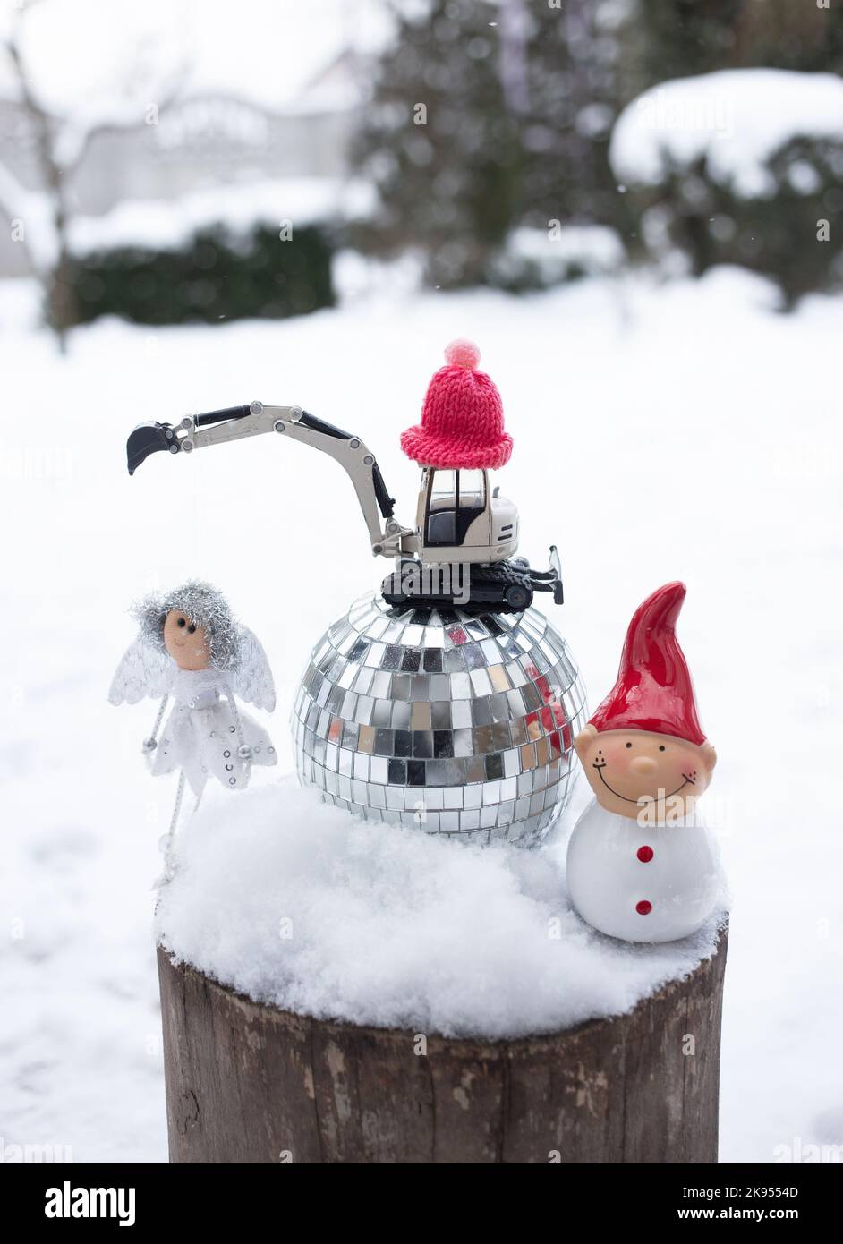 model of a toy metal excavator stands on a mirror ball, a souvenir elf ...