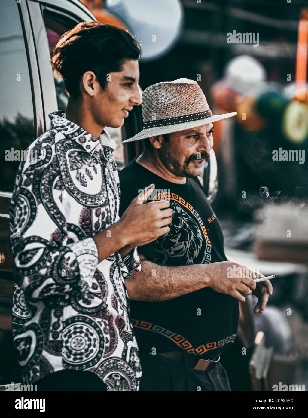 The two balkan men in the street smoking, vertical Stock Photo - Alamy