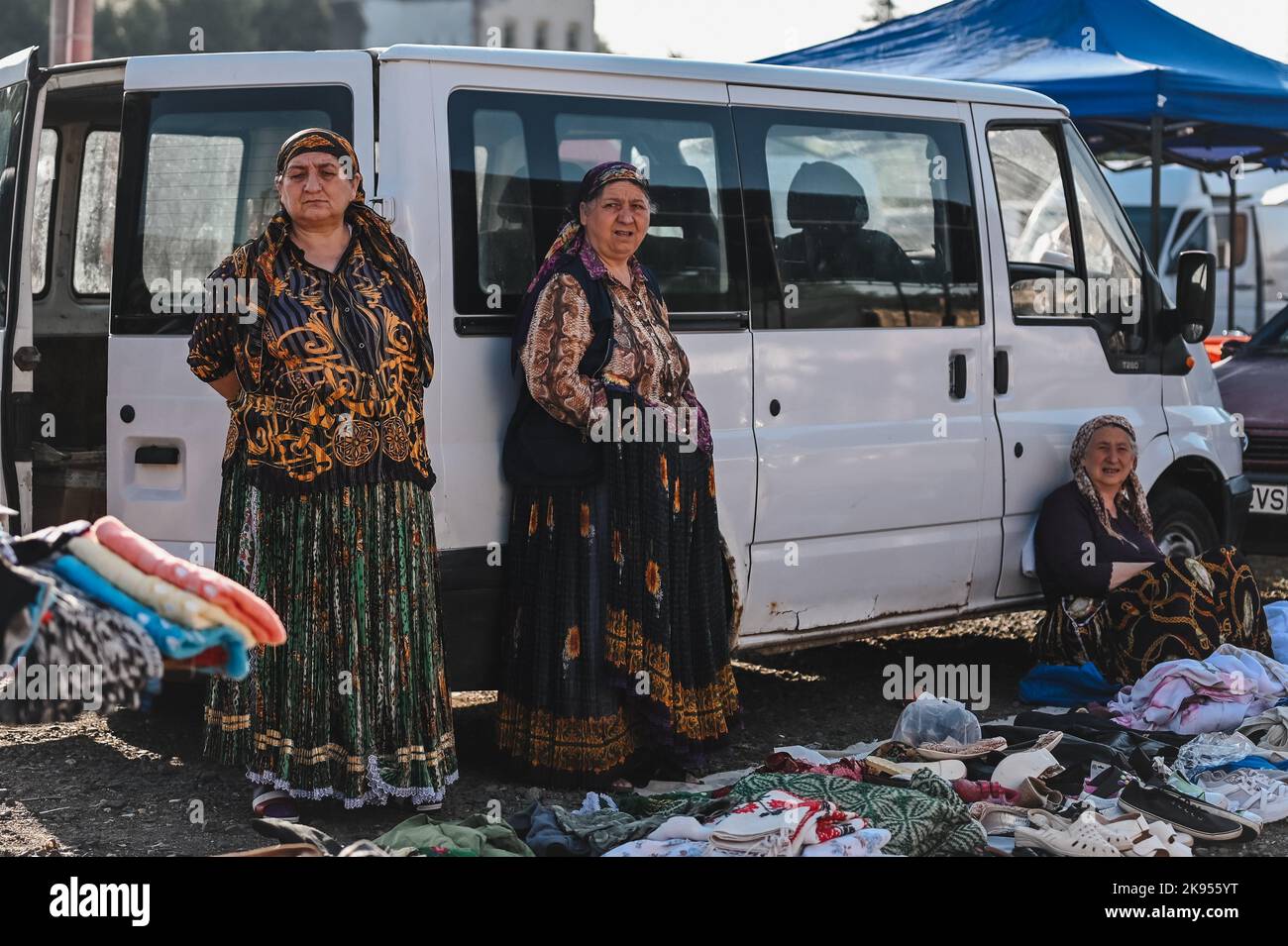 The women in traditional Balkan outfits selling clothes in front of a ...