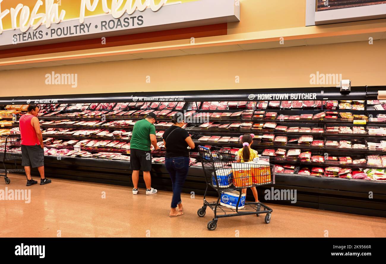 The people shopping in the meat section of a grocery store Stock Photo ...