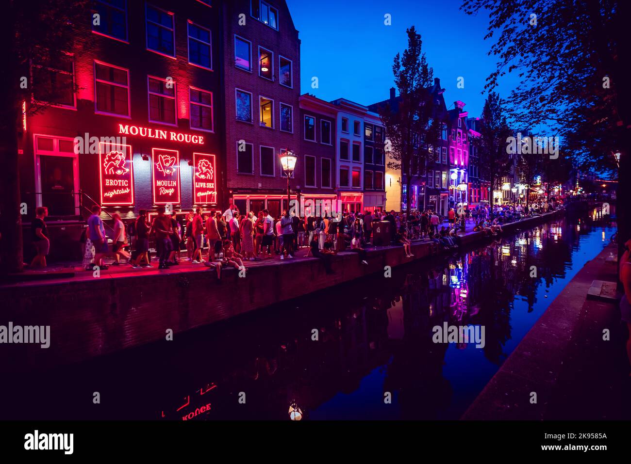 A night city view with red lights and a canal in Amsterdam, Netherlands ...