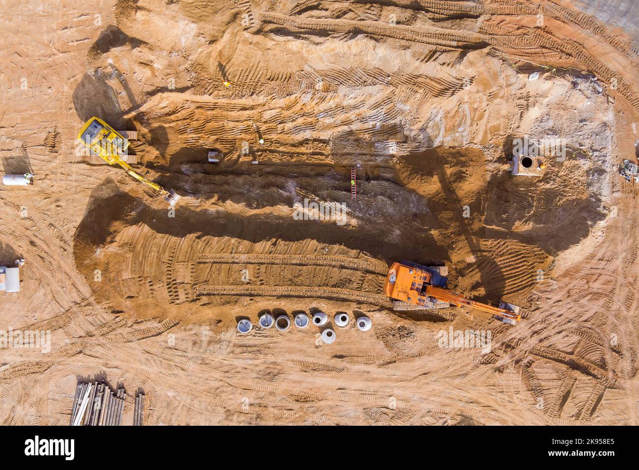 Excavators digging trench to lay sewer pipes and connect underground ...