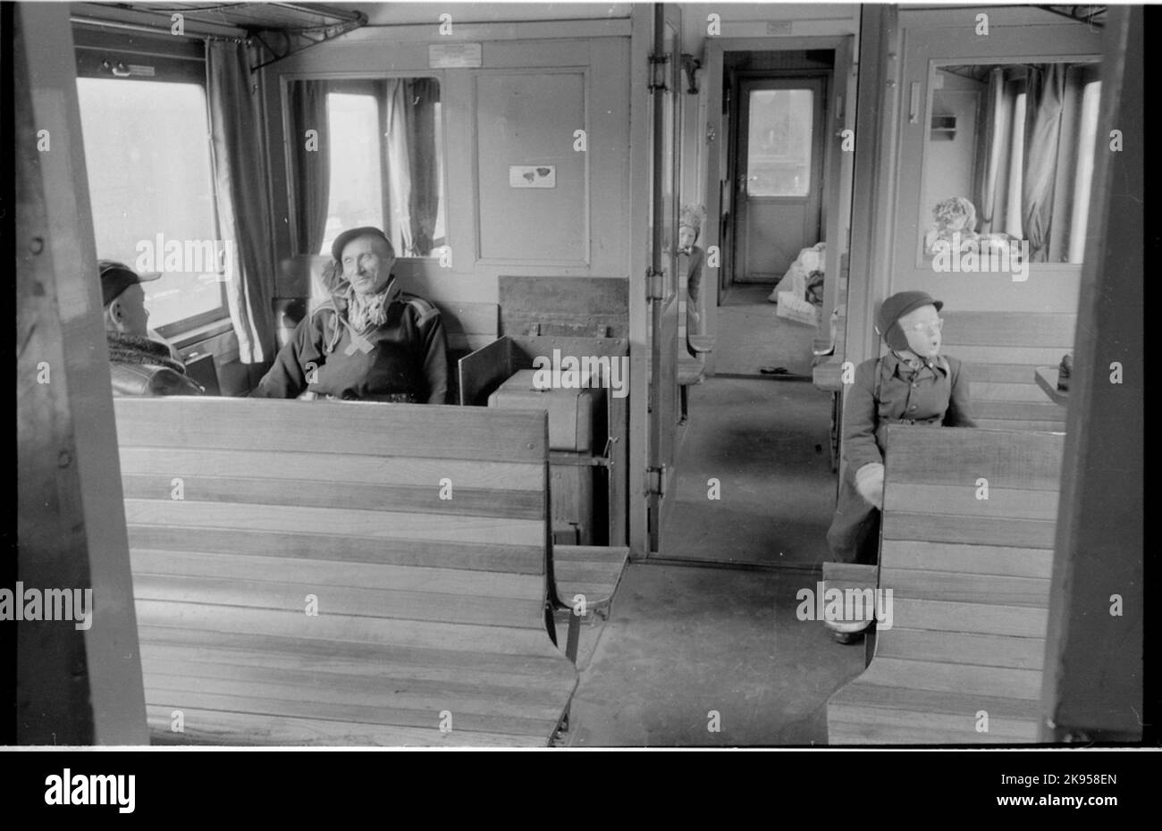 Train travelers in 3rd grade carriage Stock Photo - Alamy