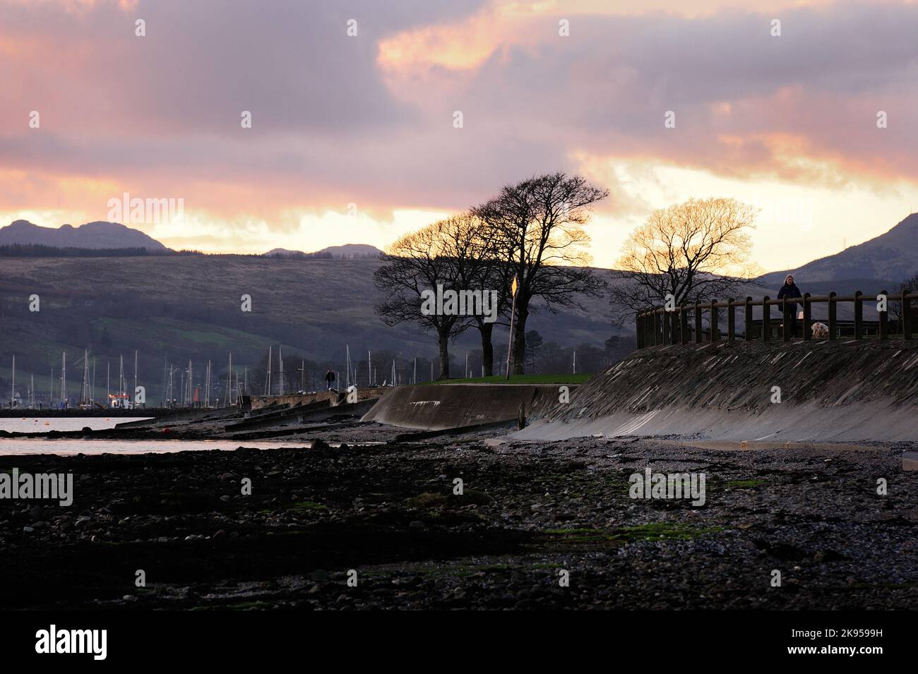 A beach scene an a golden sunset over the mountain in Helensburgh ...