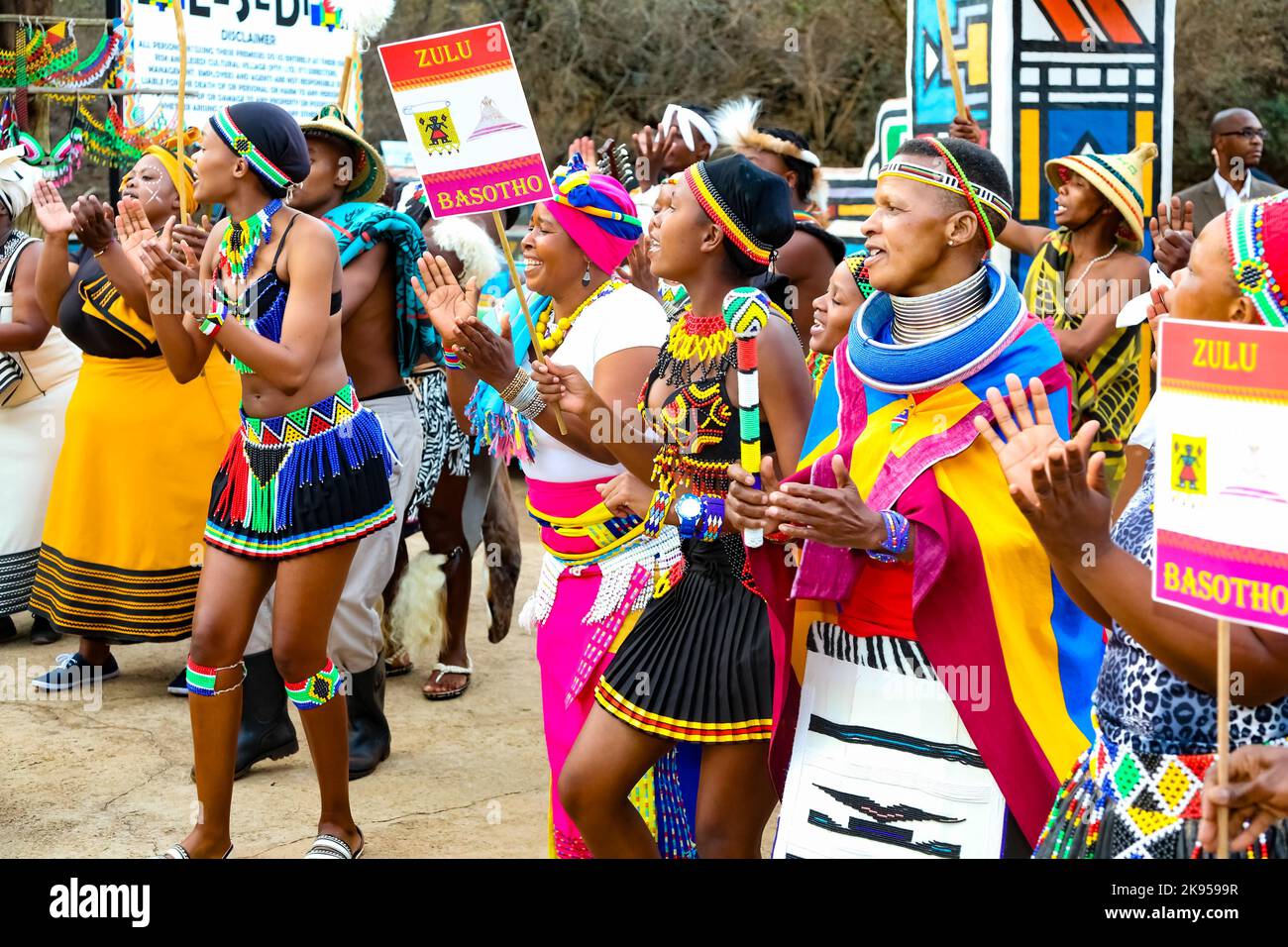 A group of African women in traditional garb costumes performing dances ...