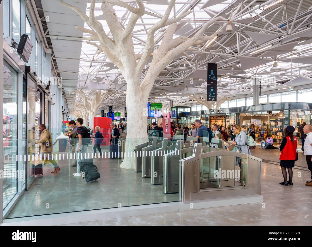 Travelers passing ticket gates in the concourse of the SNCF train ...