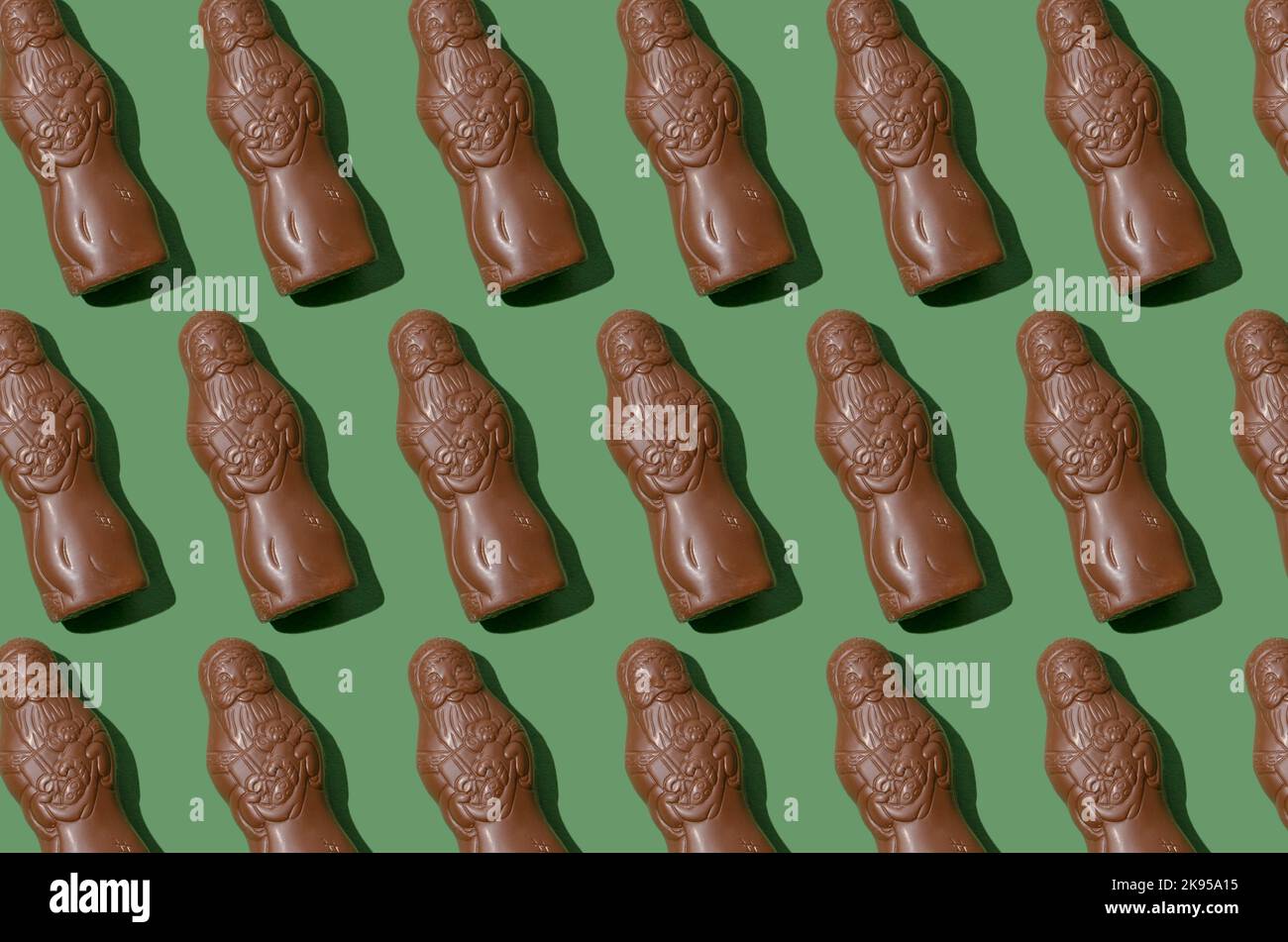 Pattern chocolate Santa Claus figure on a green background. Sweet ...