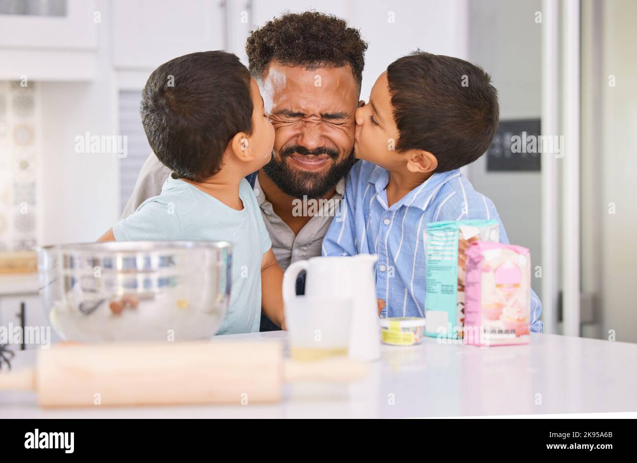 Father, cooking kiss and children in a home kitchen for baking food ...