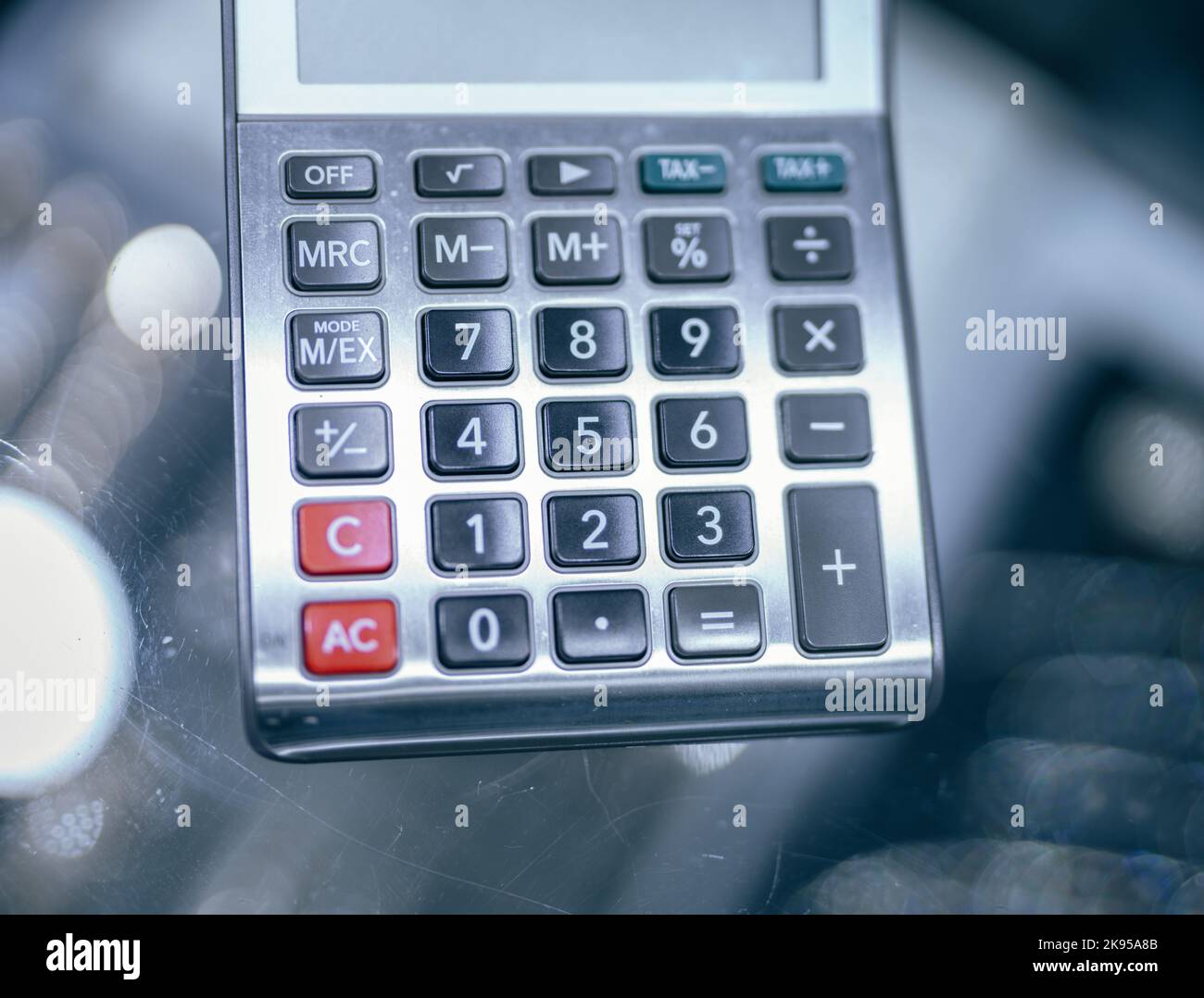 A high-angle shot of a calculator on the glass Stock Photo - Alamy