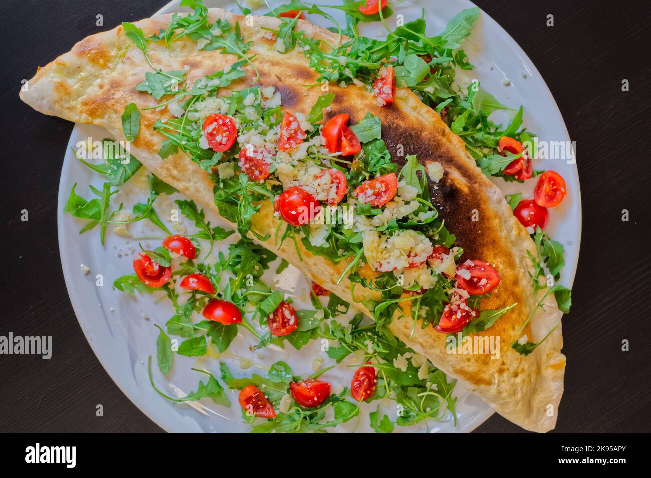 A closeup of delicious calzone on a white plate Stock Photo - Alamy