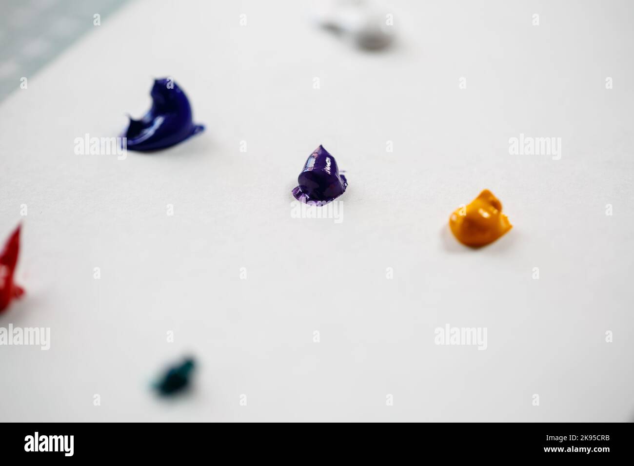 Paints squeezed out of a tube on a white sheet. They are for drawing on ...