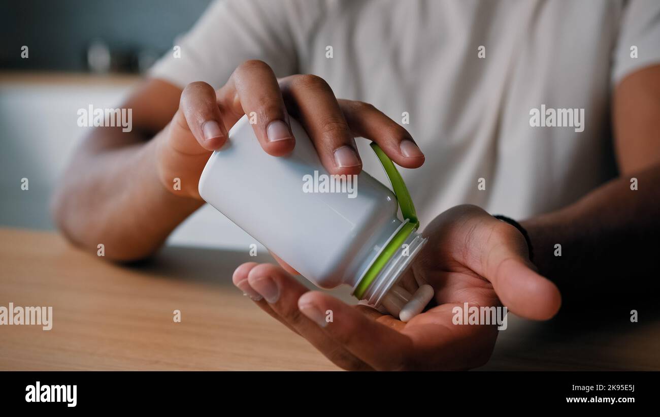 Close-up male hands holding pills painkiller medical drug dose ...