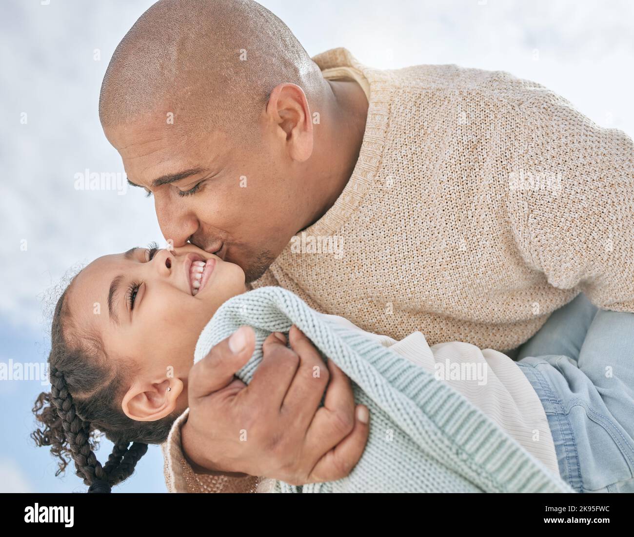 Love, sky and father kiss kid while having fun, play and enjoy outdoor ...