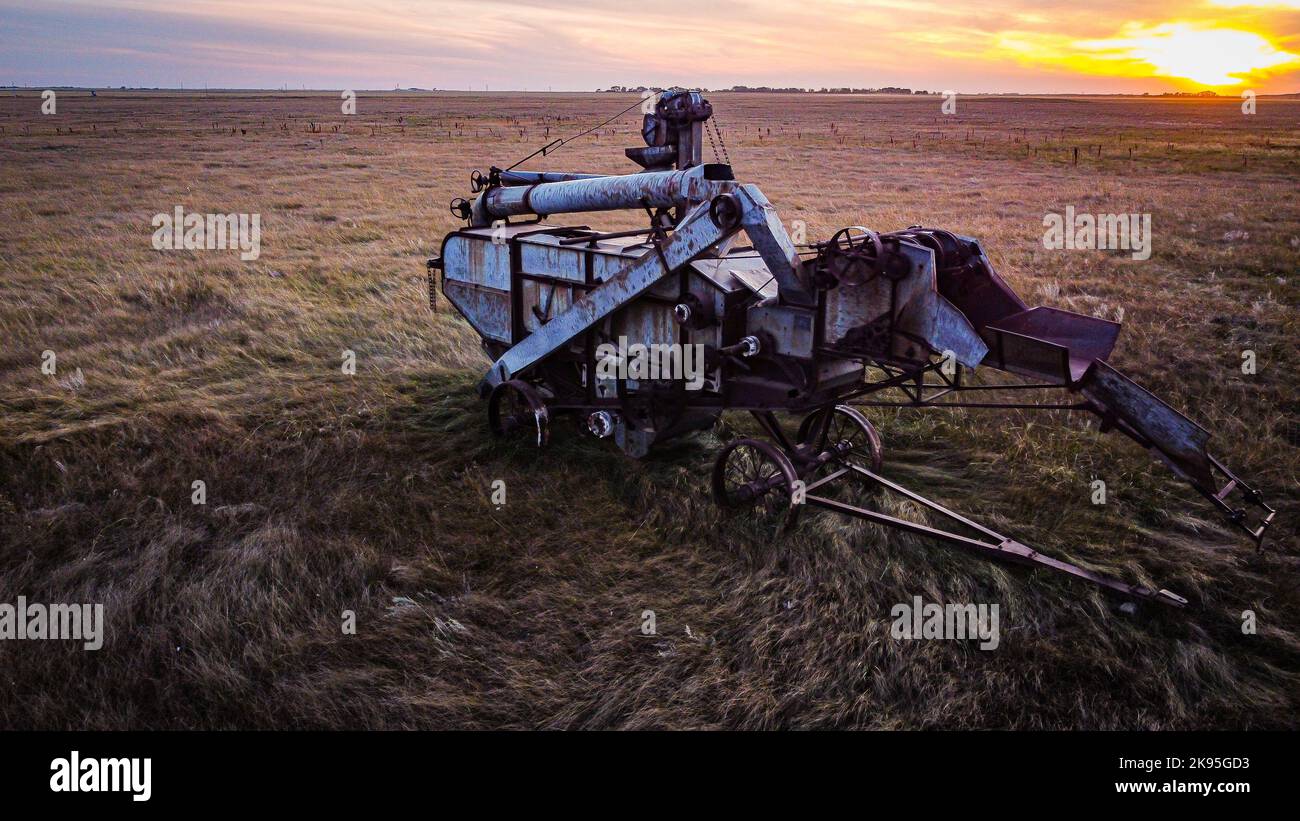 Combine in the sunset Stock Photo - Alamy