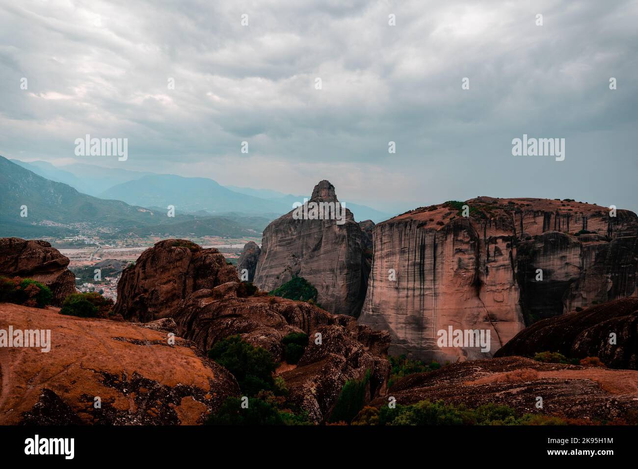 An aerial view of the Meteora, a rock formation in Greece under cloudy ...