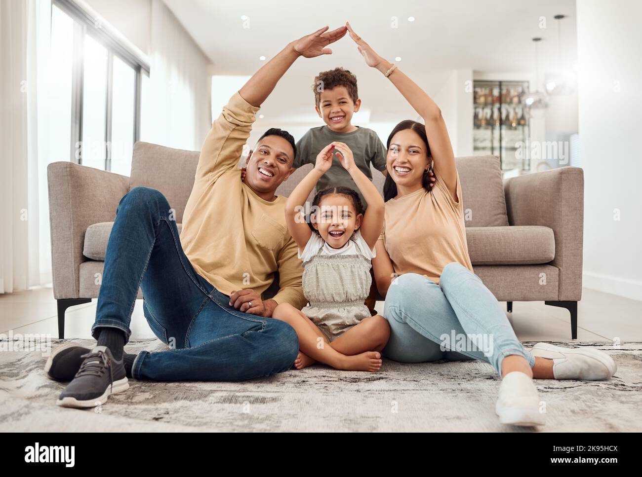 Roof, portrait and happy family with safety gesture while sitting in ...