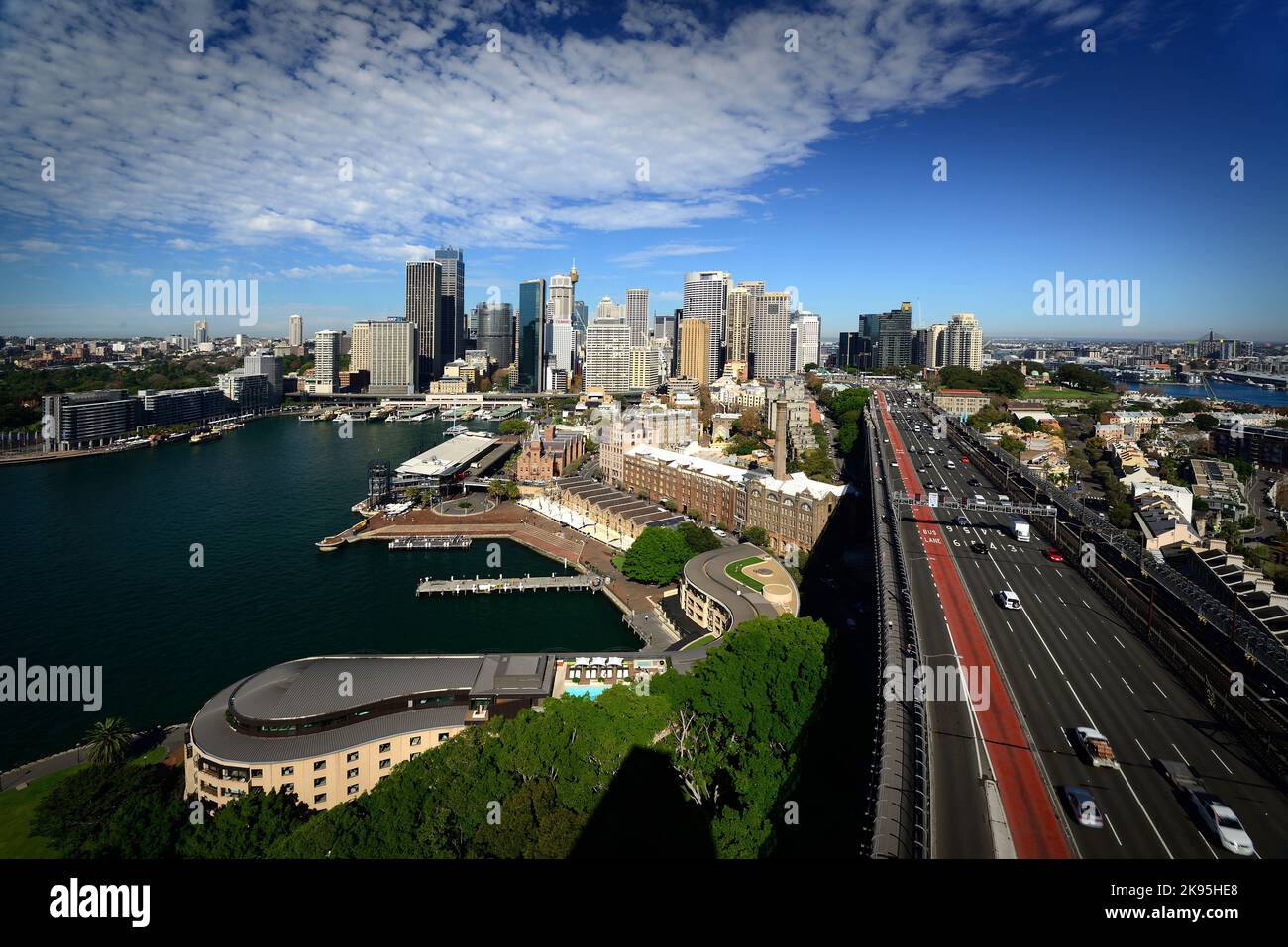 An aerial shot of the Sydney cityscape in Australia with cars driving ...